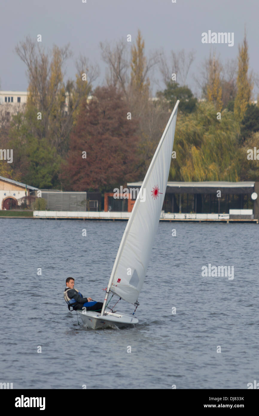 Laser Standard sailboat sailing in the early morning on Herastrau Lake ...