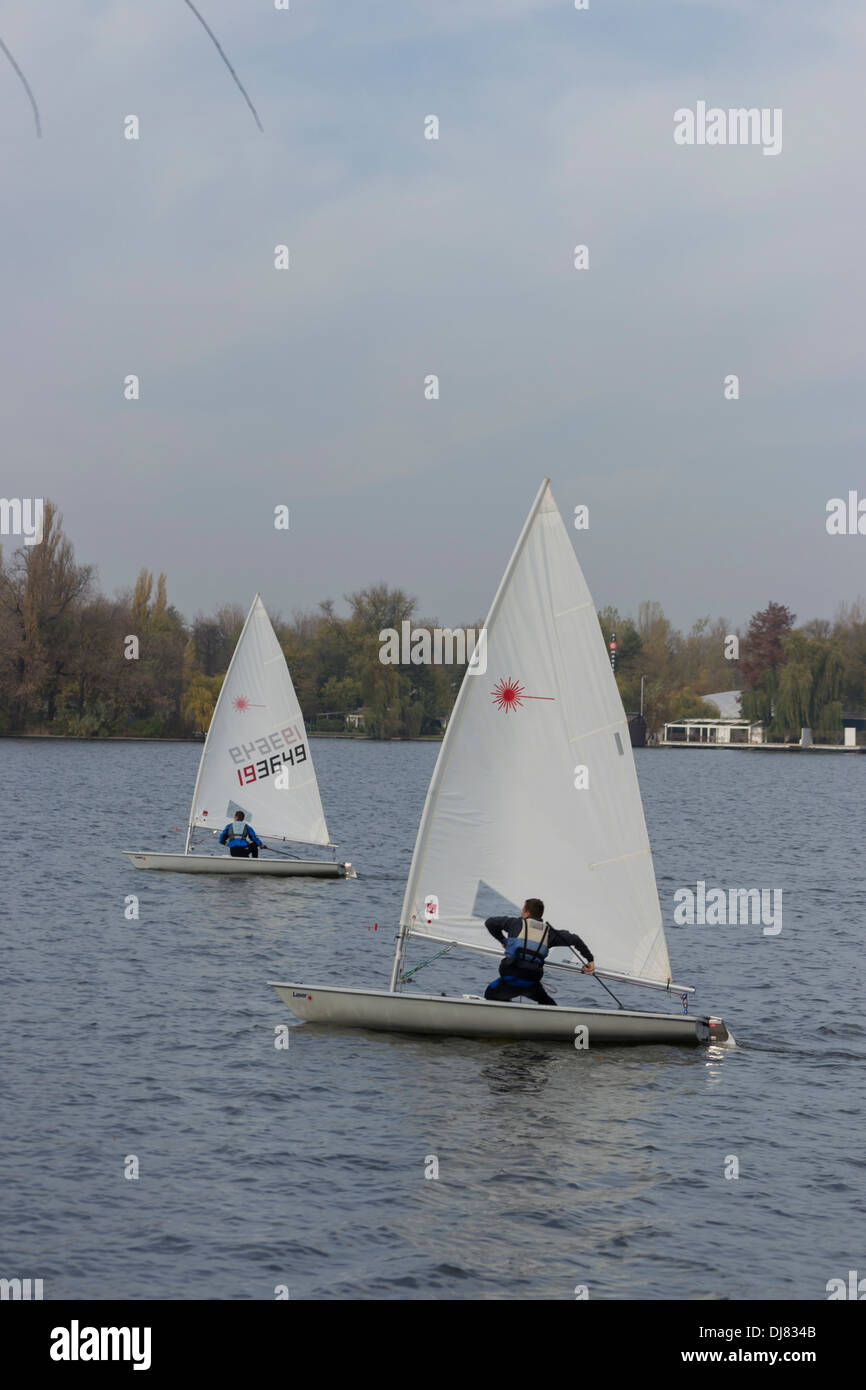 Laser Standard sailboats sailing in the early morning on Herastrau Lake ...