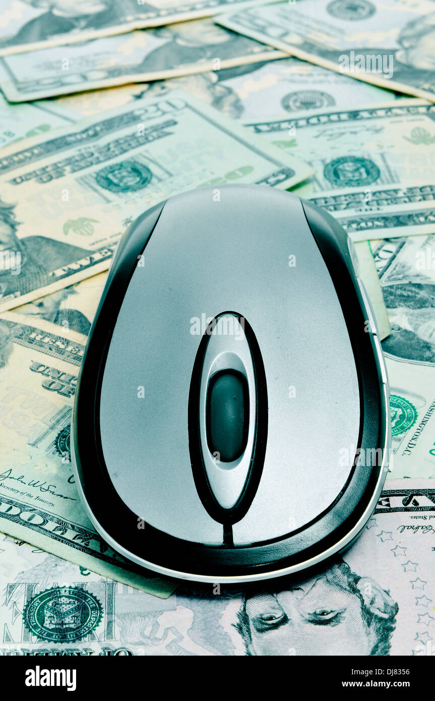 a computer mouse on a background full of dollar banknotes, depicting ...