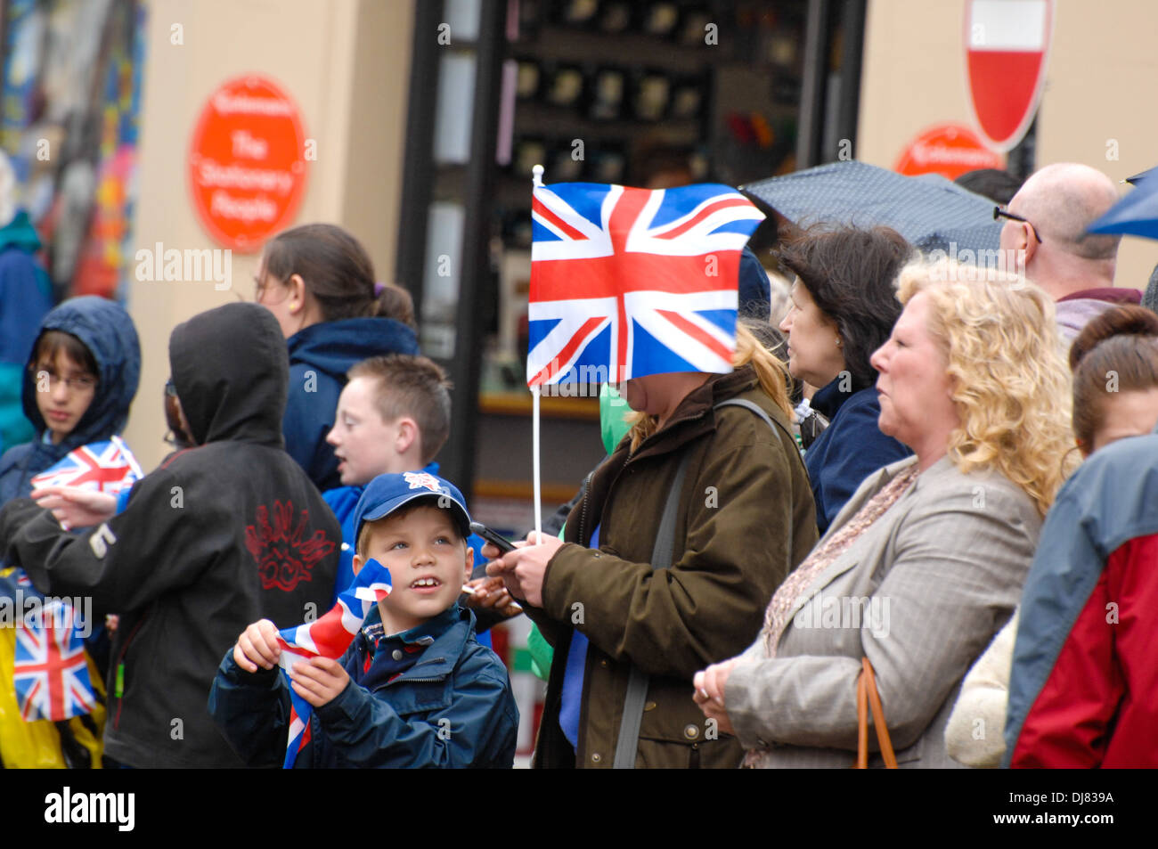 Patriotic crowd waving Union Jack flags during the 2012 Olympic games ...