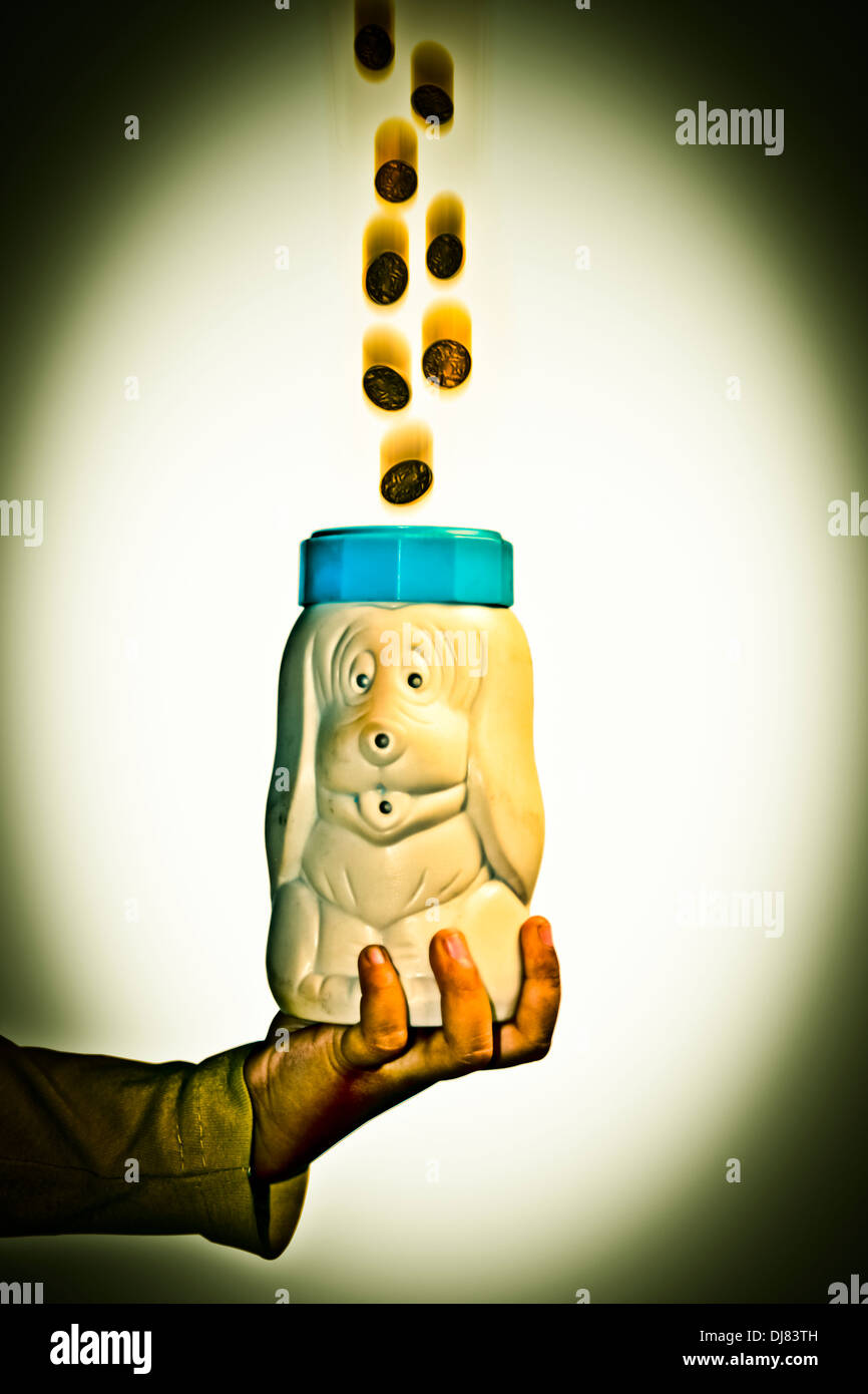 Money bank in girl's hand Stock Photo - Alamy