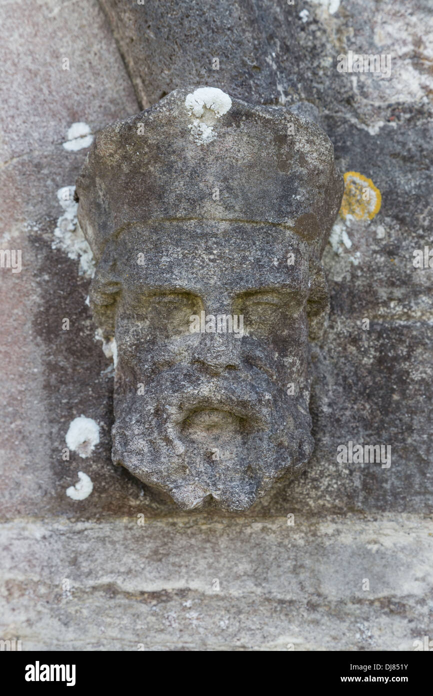 Stone face / gargoyle on St. Edwards Church tower in Corfe Castle ...