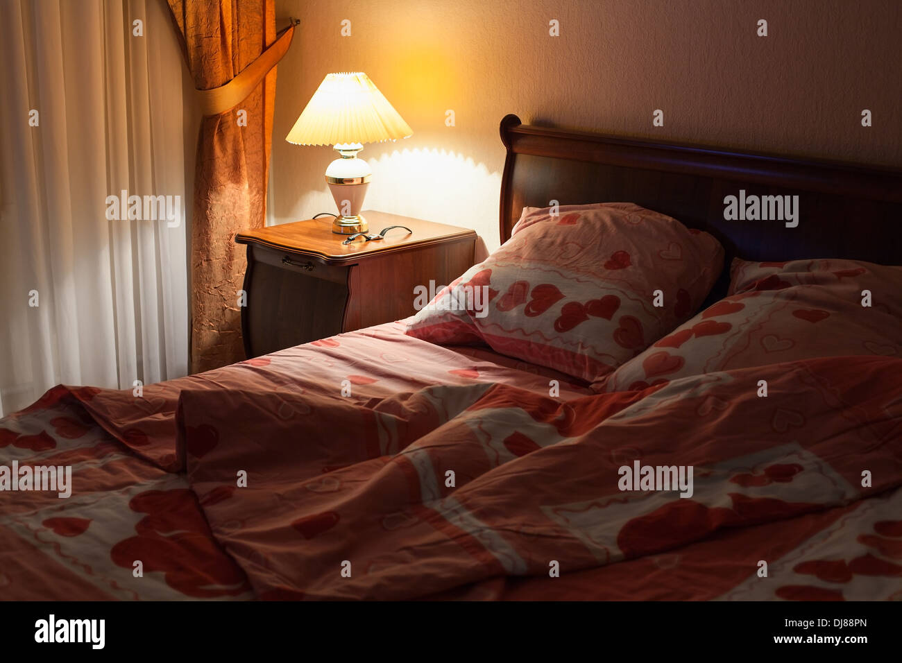 Bedroom interior with table-lamp at night Stock Photo - Alamy
