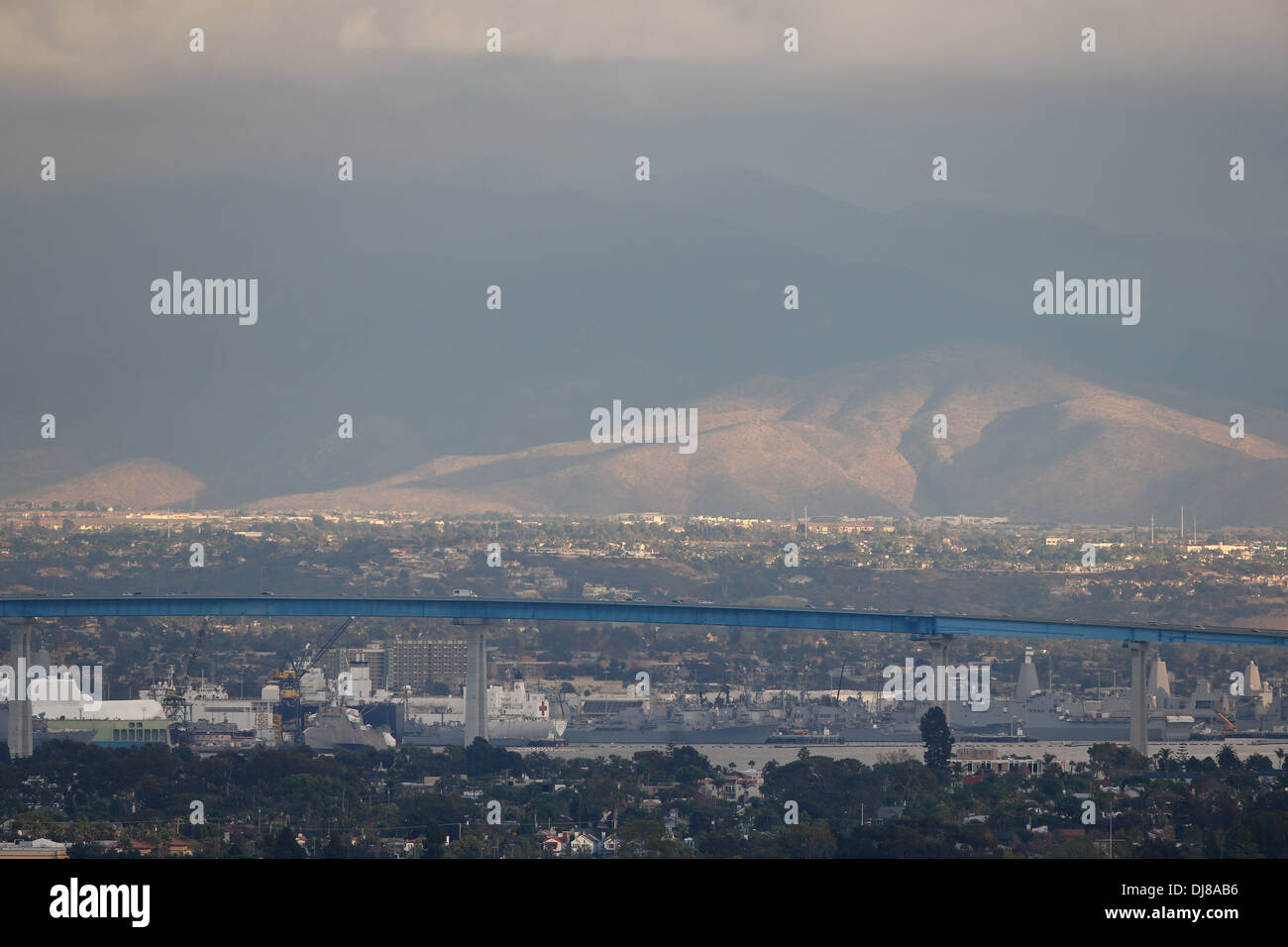 The San Diego-Coronado bridge with Otay Mountain and Mexico in the ...