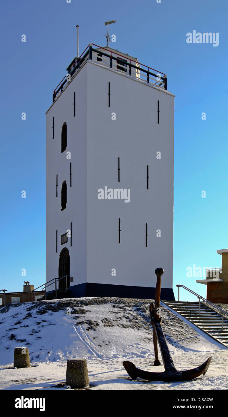 Lighthouse in winter, situated on the seafront of the coastal village ...
