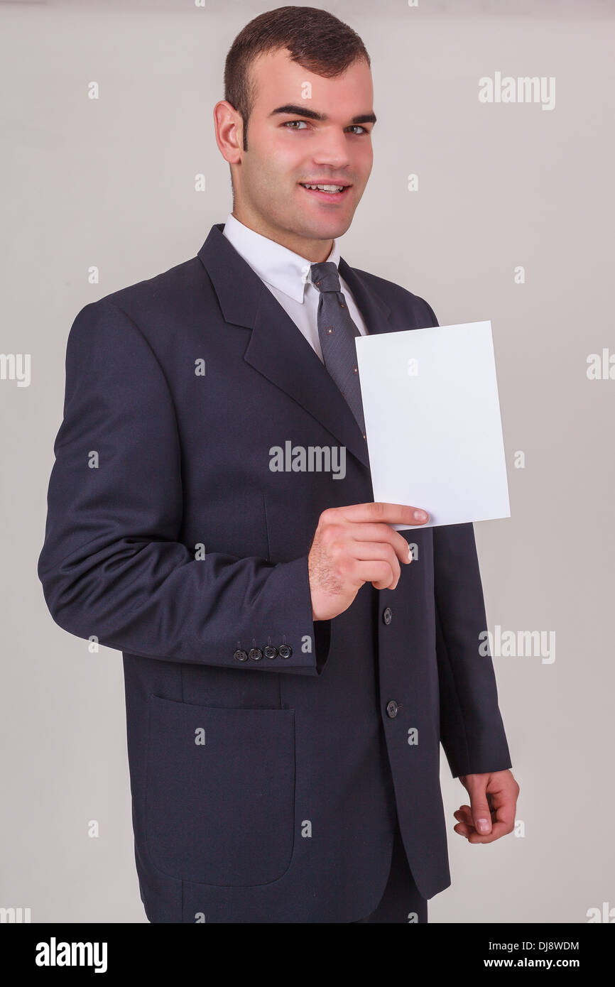 Stylish businessman holding a small blank sign Stock Photo - Alamy
