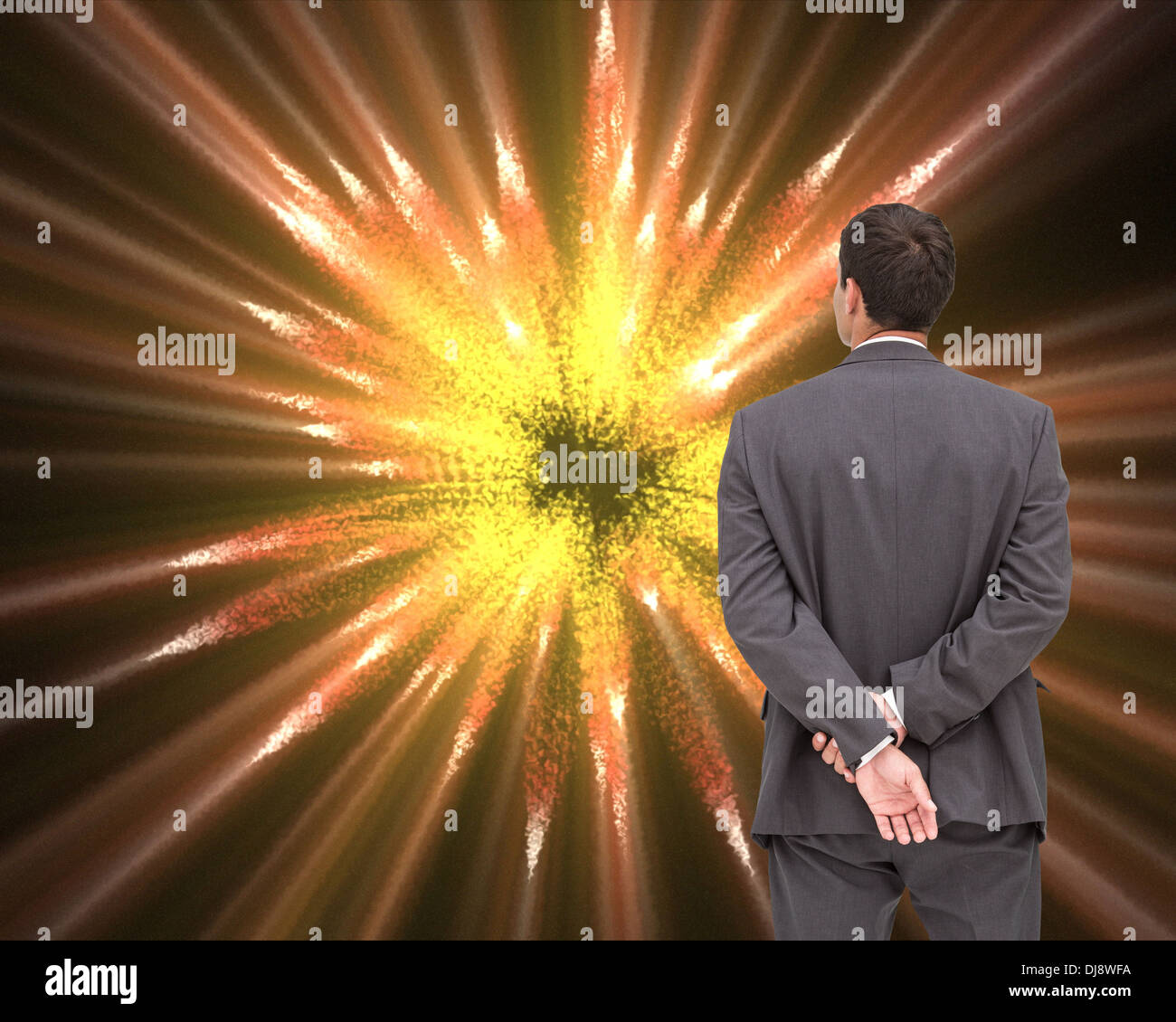 Businessman standing with hands behind back Stock Photo - Alamy