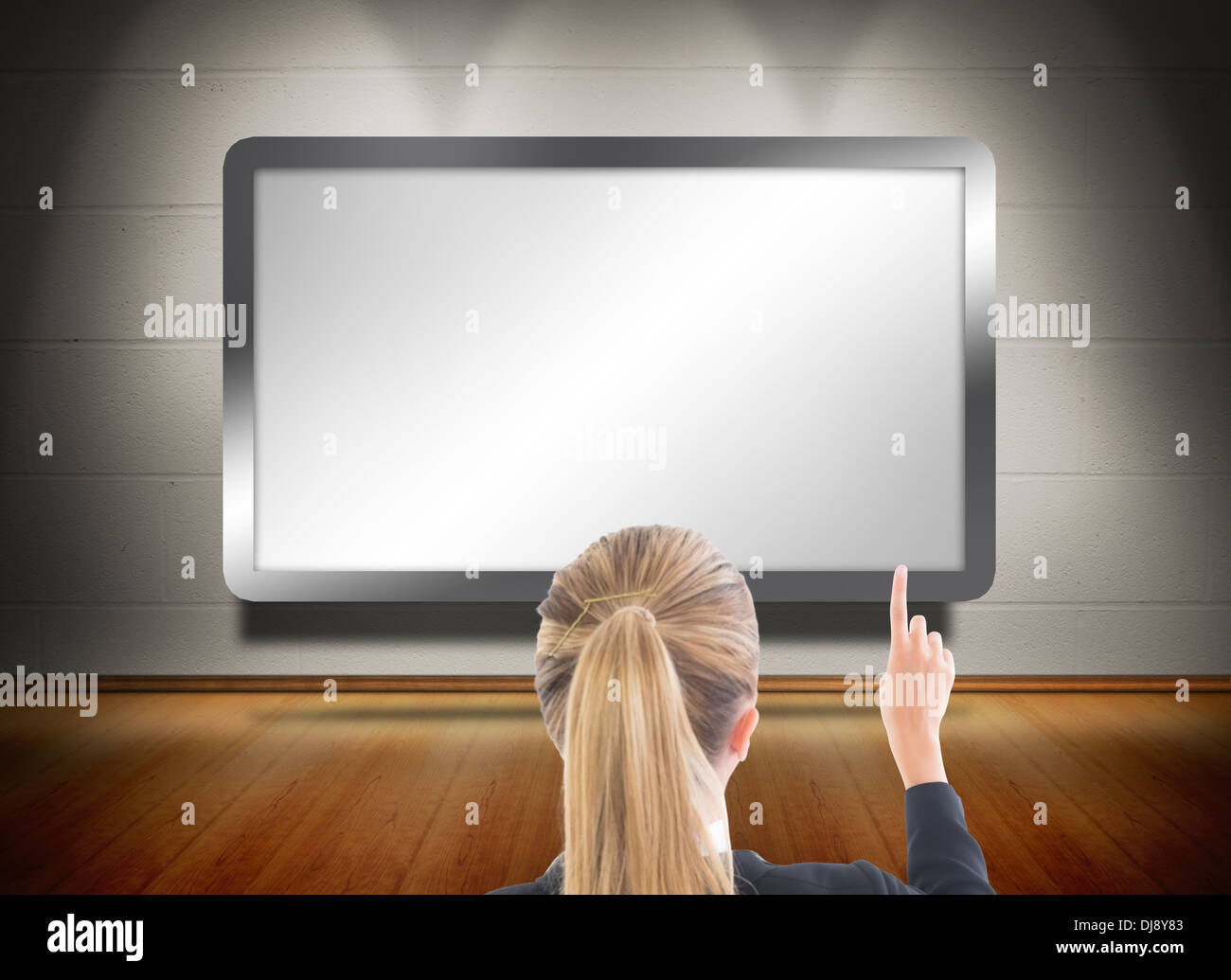 Blonde businesswoman pointing at screen Stock Photo - Alamy