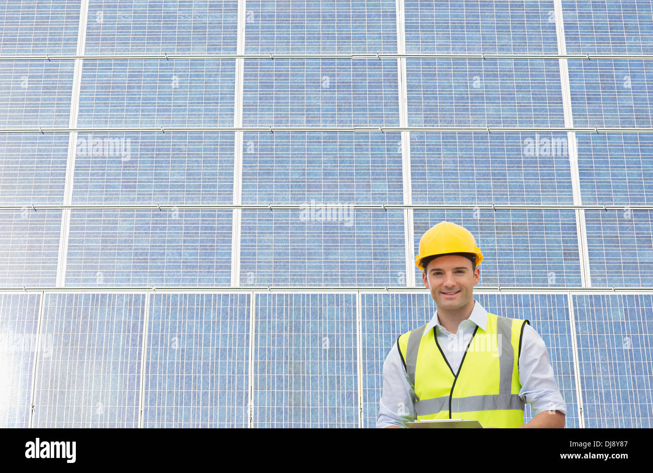 Worker standing under shade by wind turbine Stock Photo - Alamy
