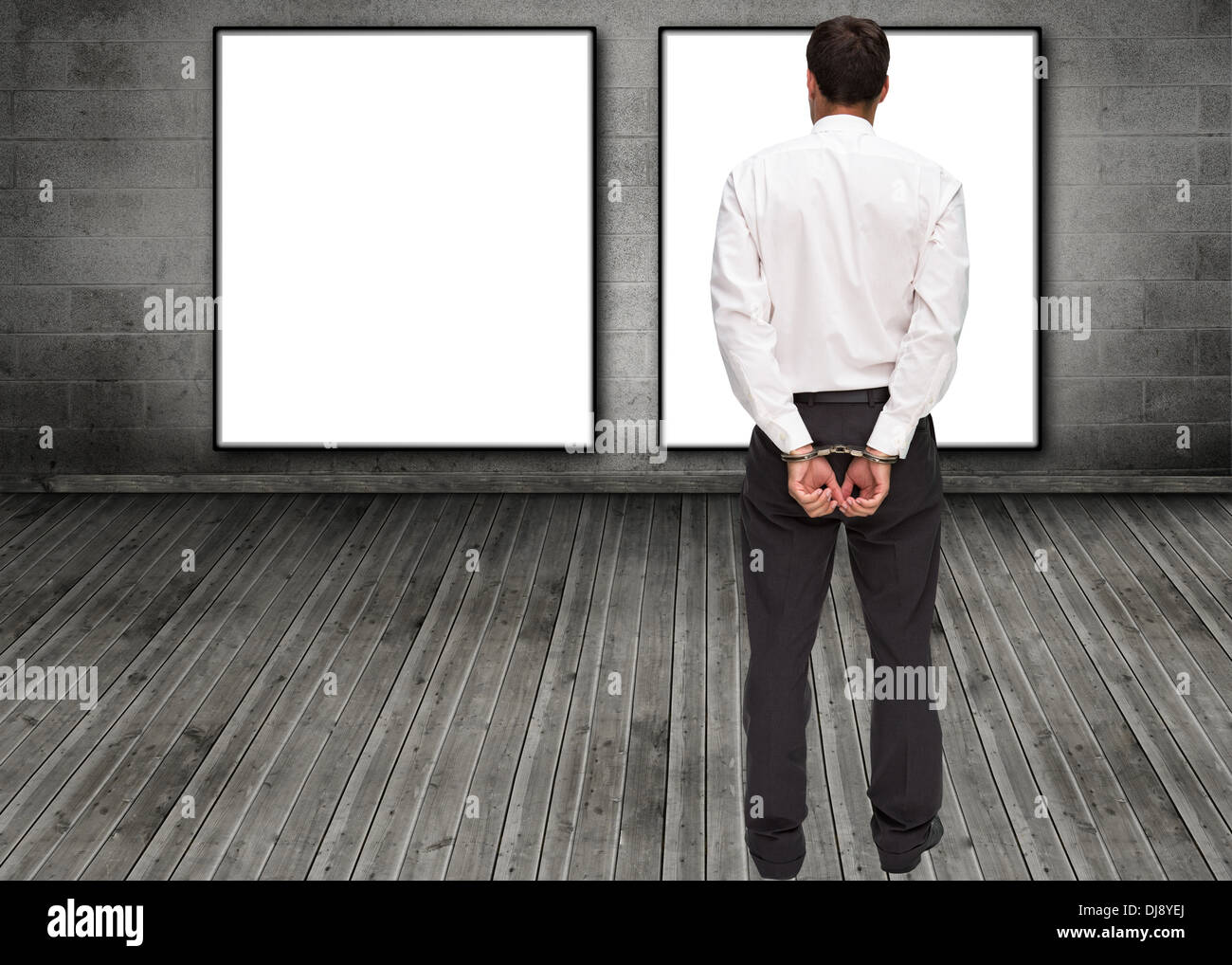 Rear view of young businessman wearing handcuffs Stock Photo - Alamy