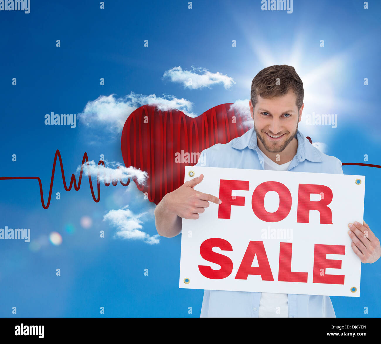 Smiling model holding a for sale sign Stock Photo - Alamy