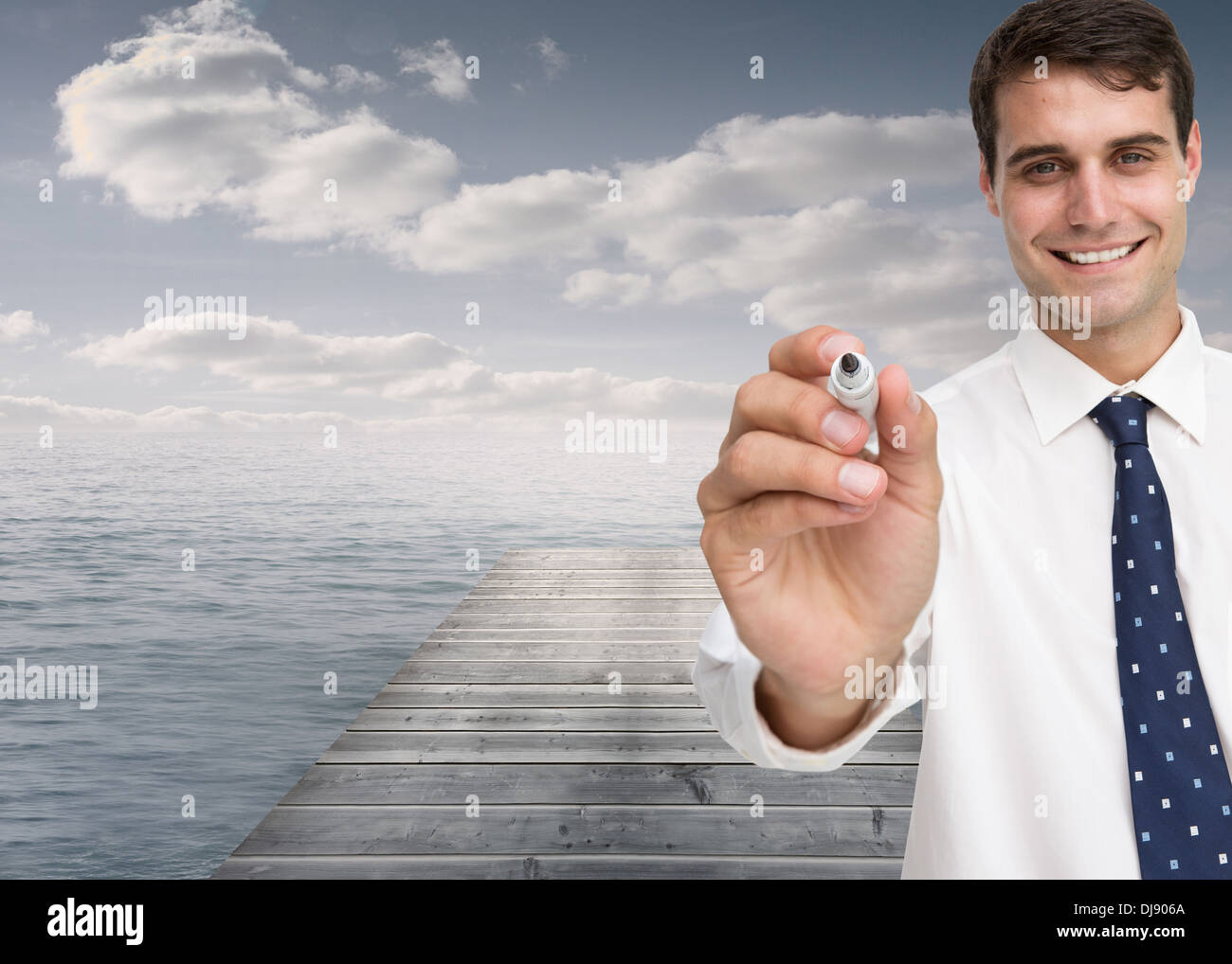 Happy businessman holding a marker Stock Photo - Alamy