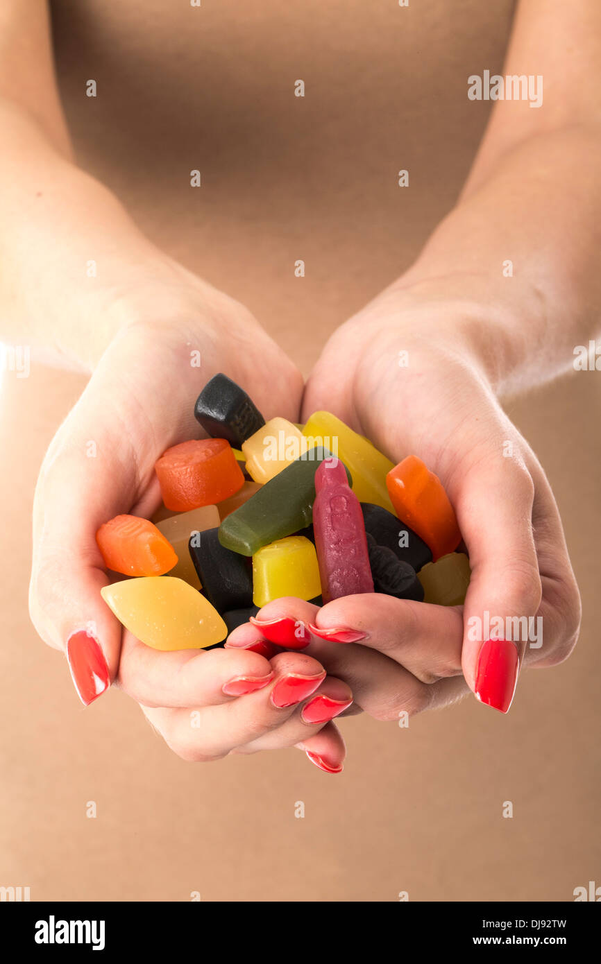 Model Released. Attractive Young Woman Holding a Handful of Sweets ...