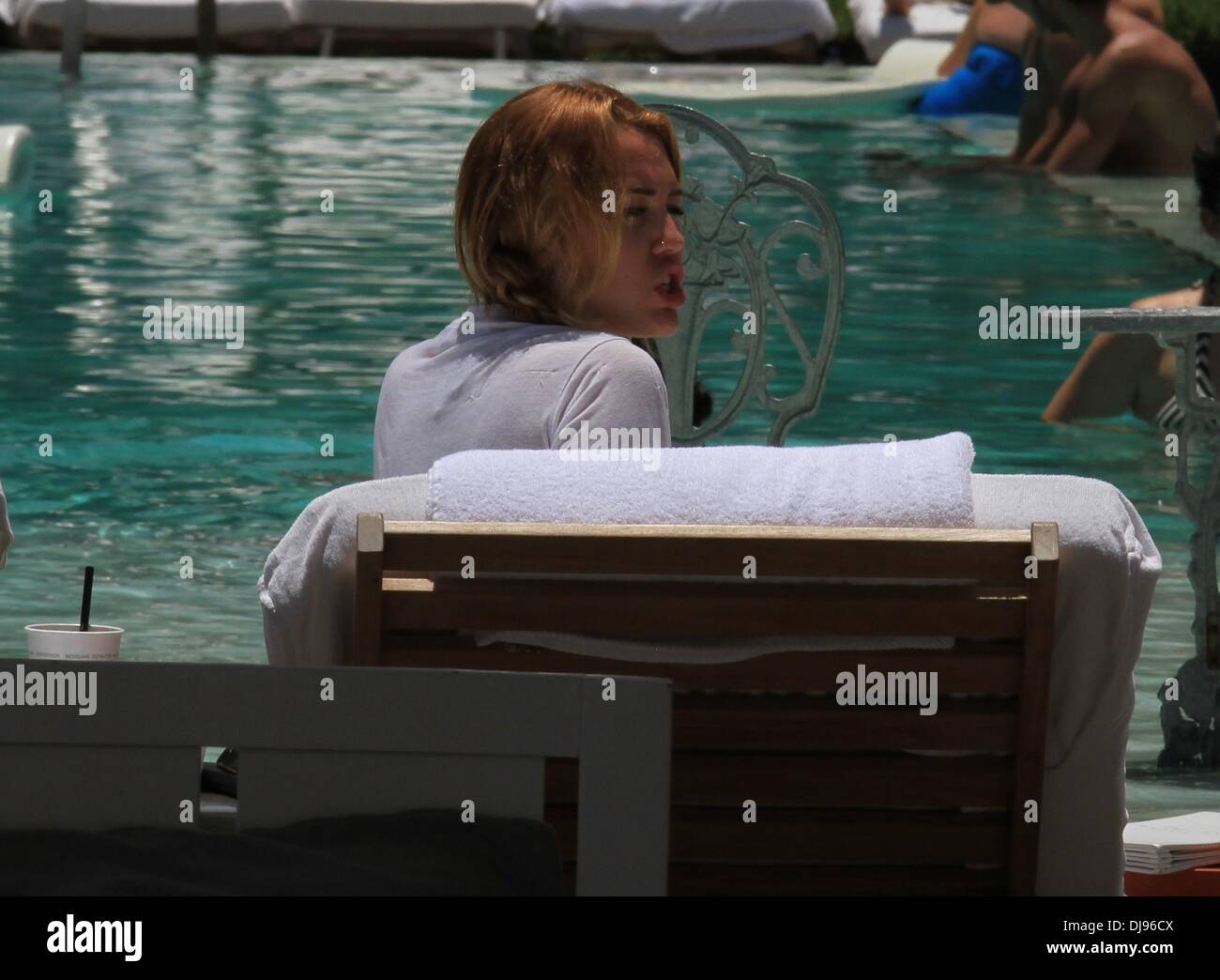 Miley Cyrus and Cheyne Thomas spend some time relaxing at the pool ...