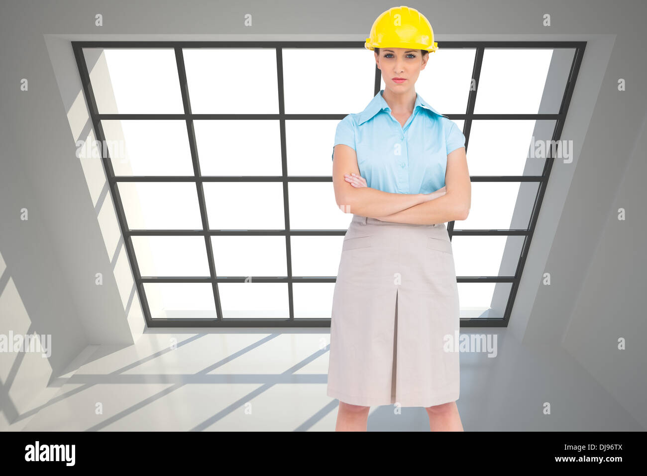 Composite image of serious pretty architect posing Stock Photo - Alamy