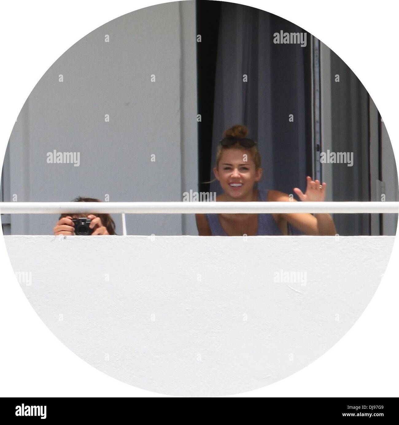 Miley Cyrus and her friend Cheyne Thomas checking out of their hotel ...