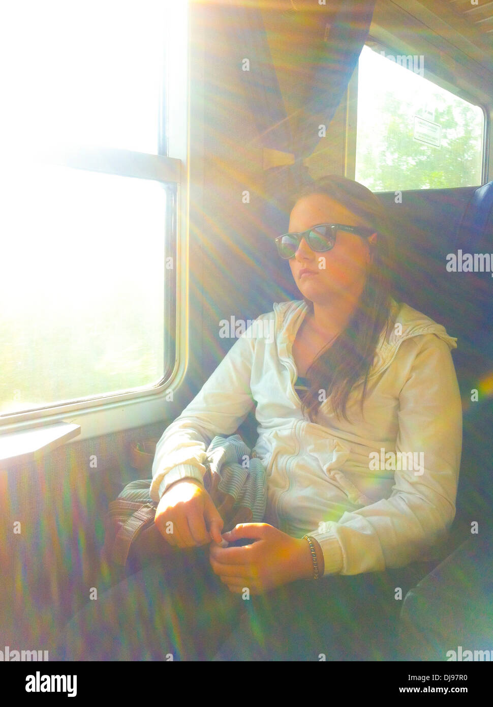 Caucasian teenage girl riding train Stock Photo - Alamy