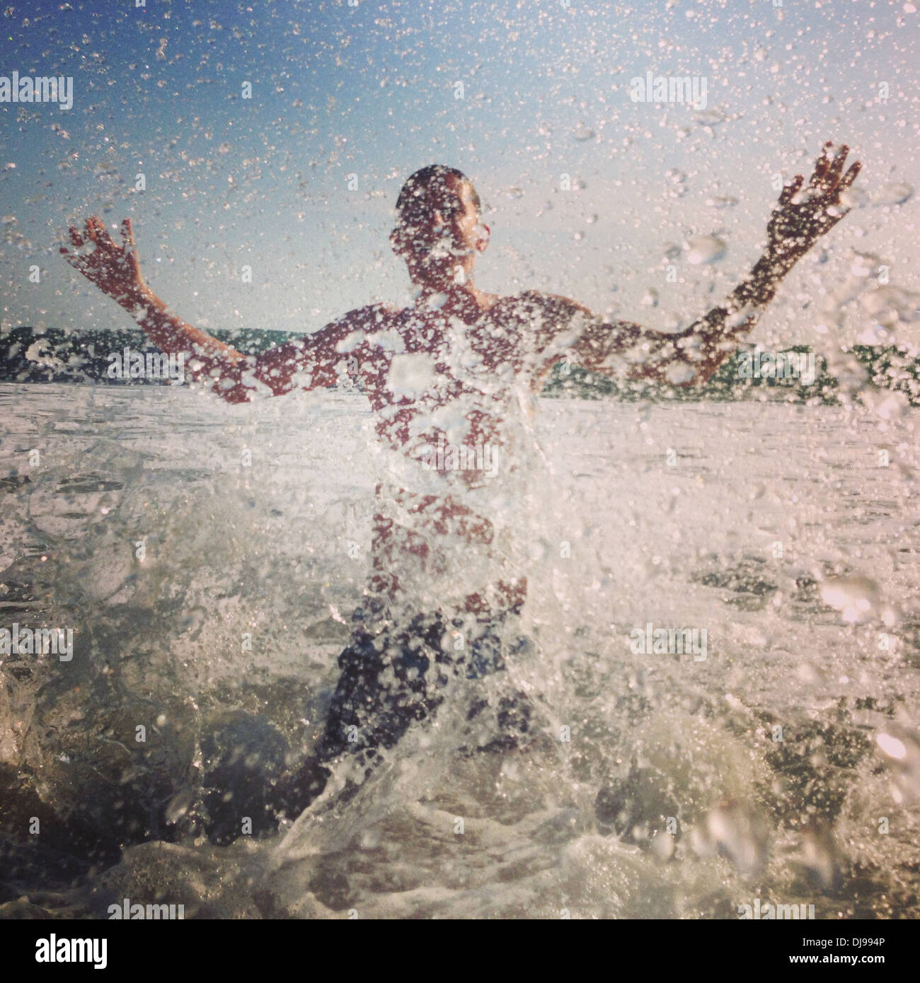 Man splashing in lake Stock Photo - Alamy