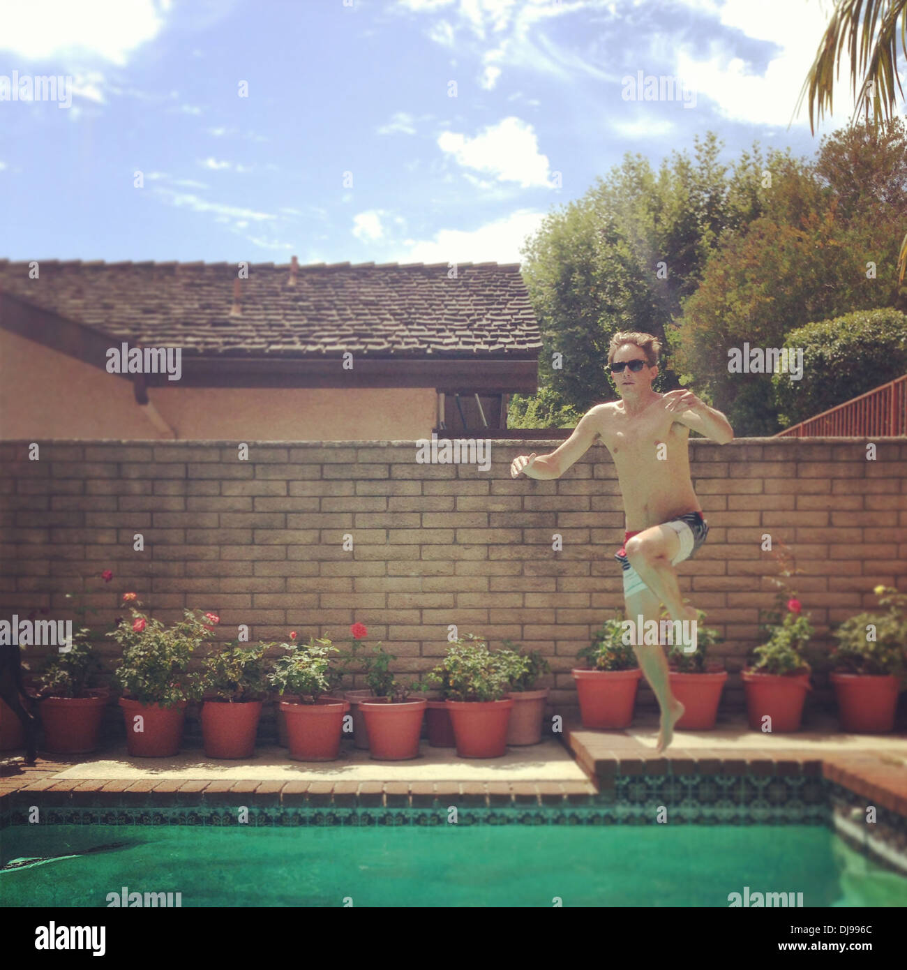 Man jumping into swimming pool Stock Photo - Alamy