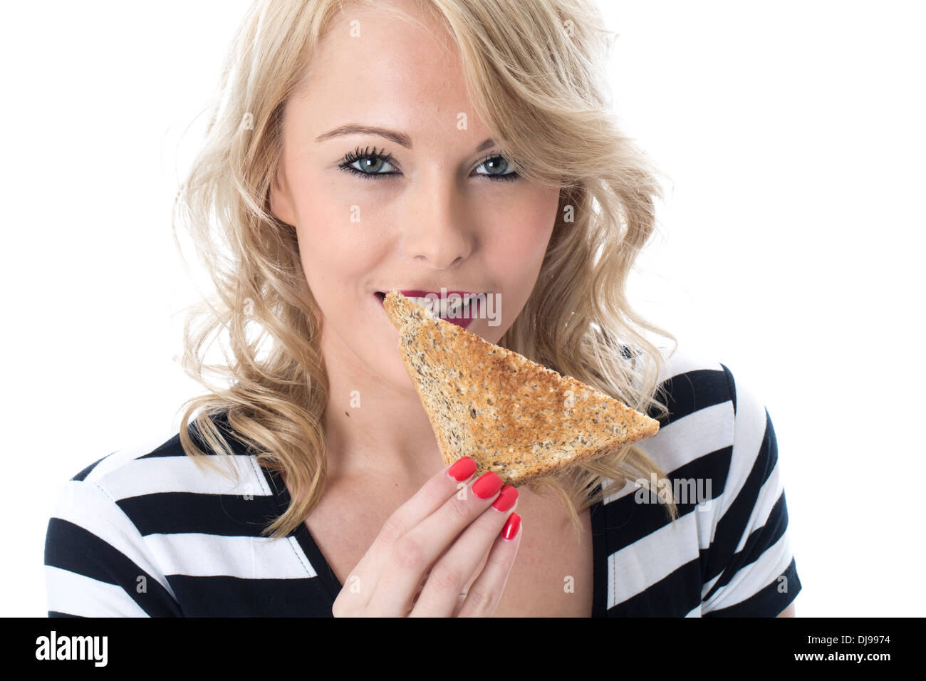 Model Released. Attractive Young Woman Eating a Slice of Toast Stock ...