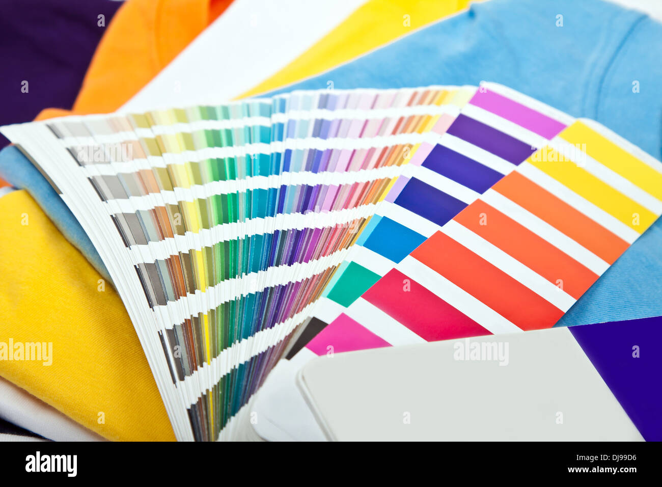 several colorful t-shirts and color scale Stock Photo - Alamy