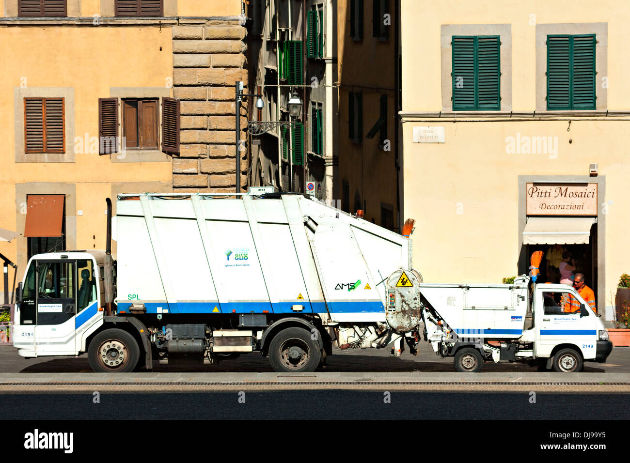 Large and small waste disposal trucks in street, Florence, Italy Stock ...