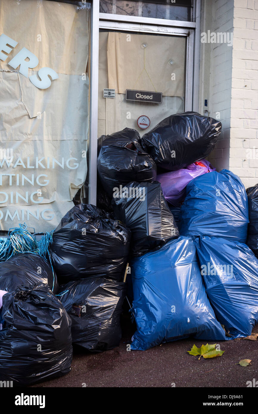 rubbish piled outside a shop,background, bag, bin, bottle, cardboard ...