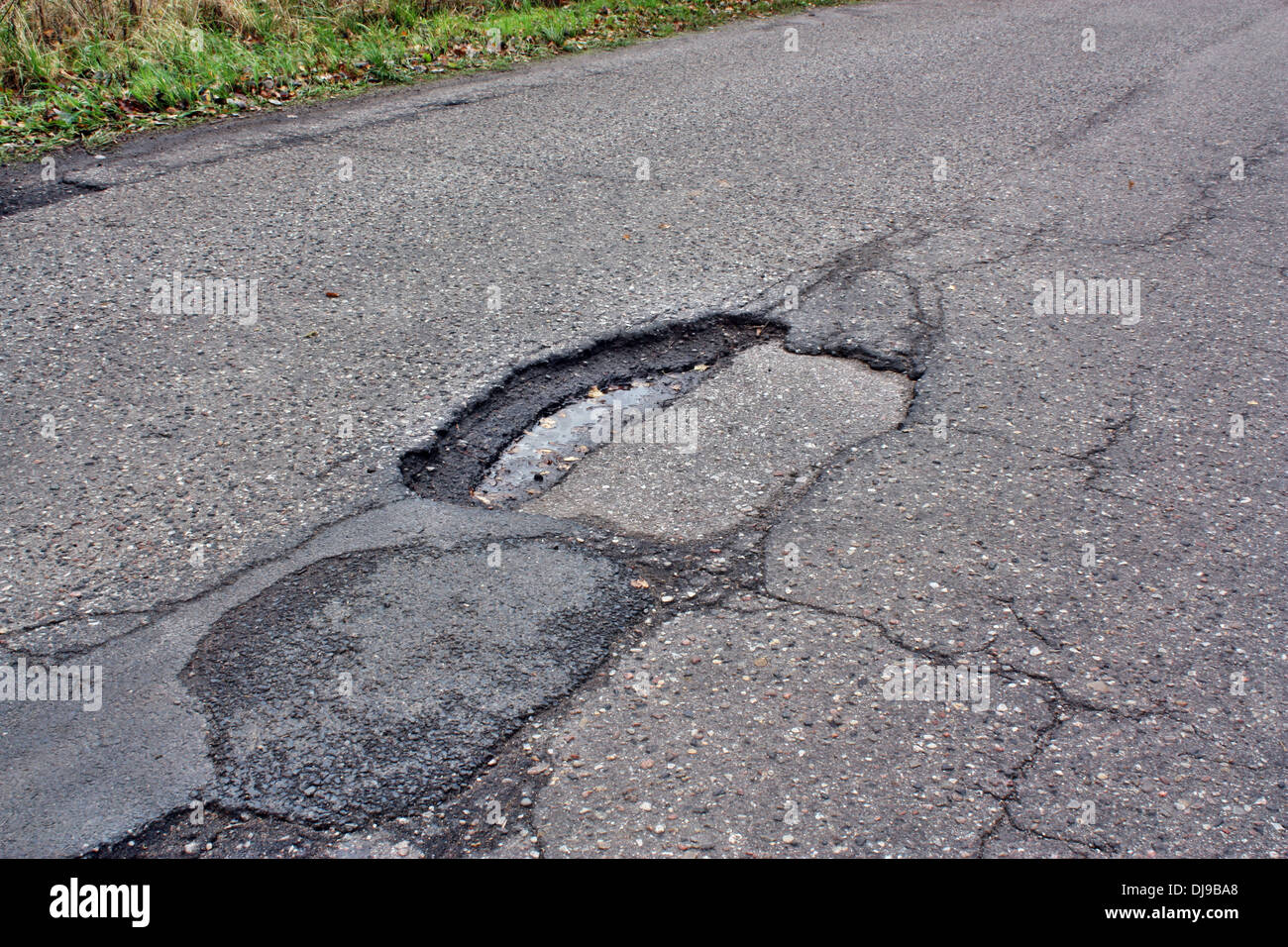 A large hole in the pavement asphalt gap Stock Photo - Alamy