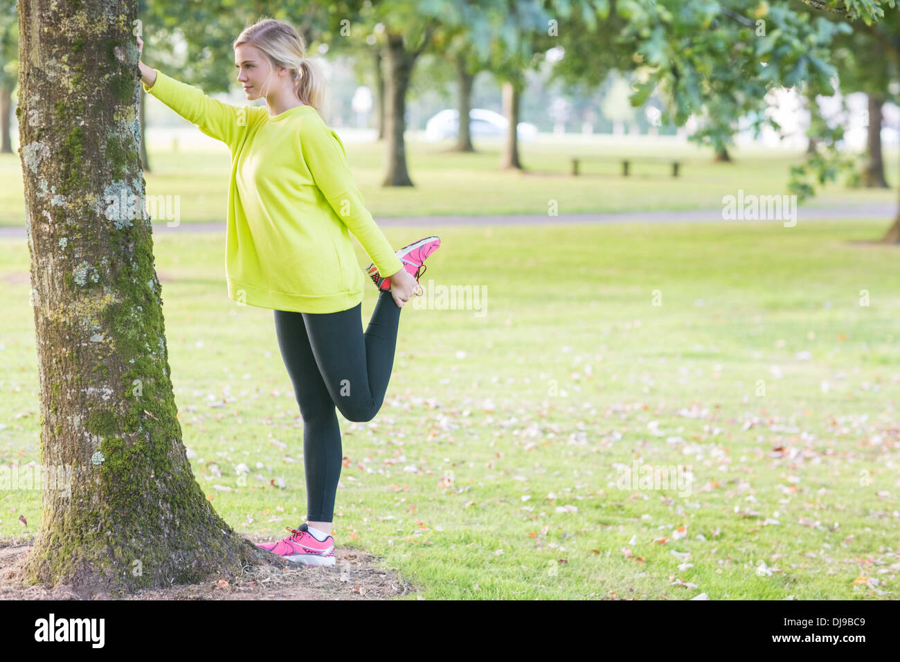 Fit beautiful blonde stretching leg Stock Photo - Alamy