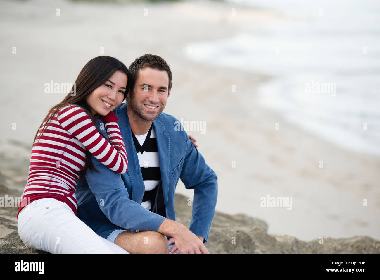 Couple smiling together on beach Stock Photo - Alamy