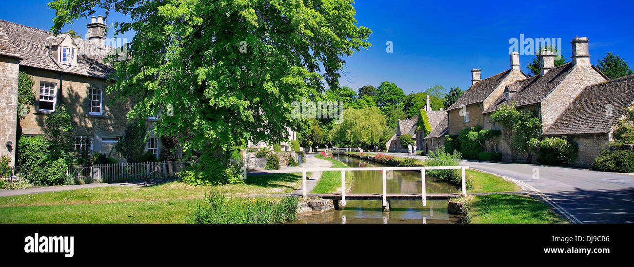 A spring view with a bridge over the River Eye at Lower Slaughter ...