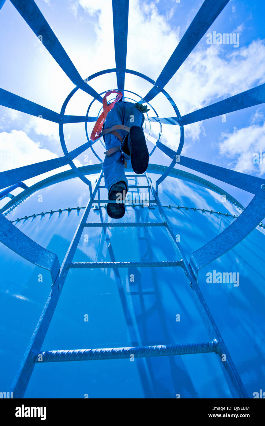 Man climbing water tower ladder Stock Photo - Alamy