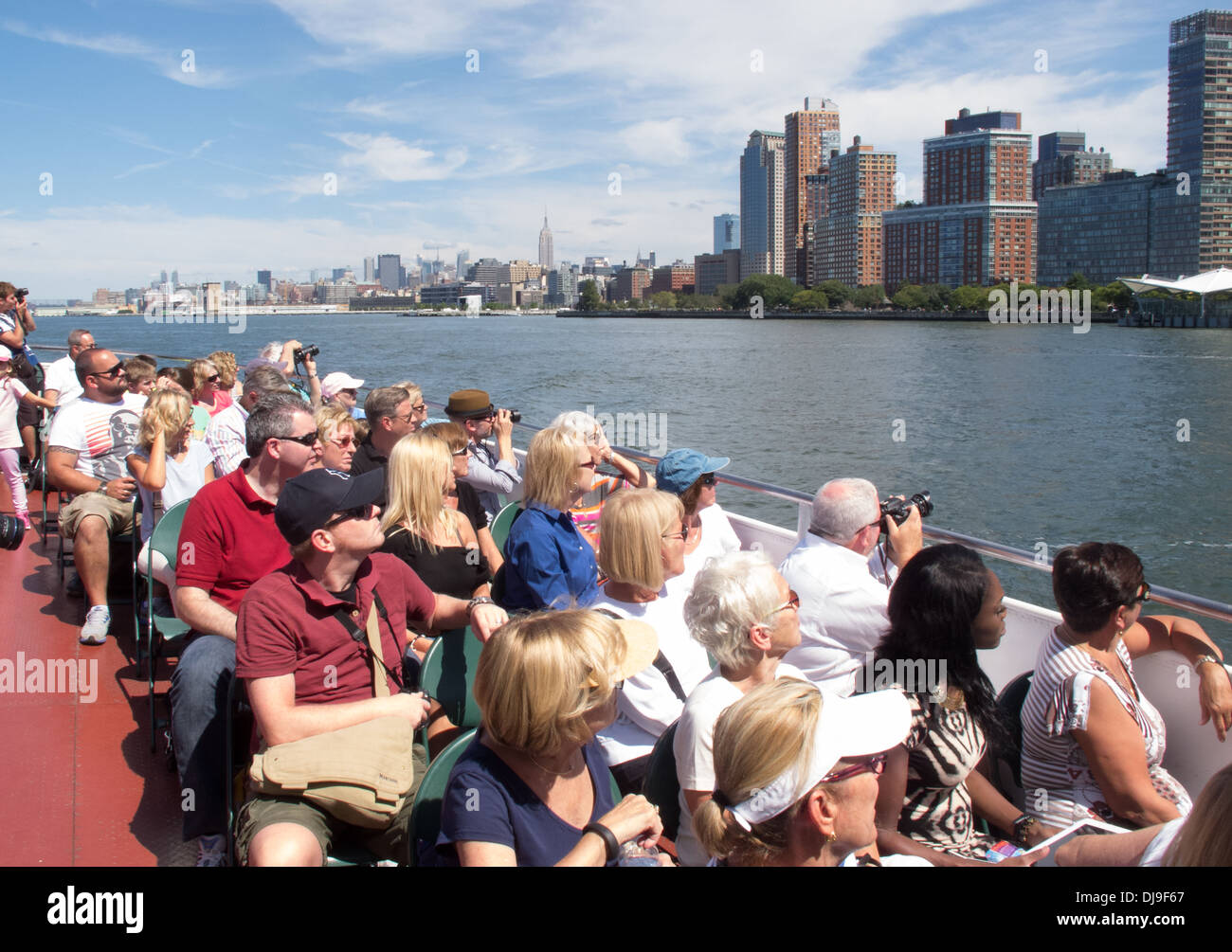 Tourists on Circle Line Sightseeing Cruise looking at Manhattan Stock ...