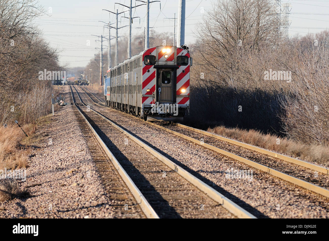 Train arriving at suburban commuter train station. Trains run backwards ...