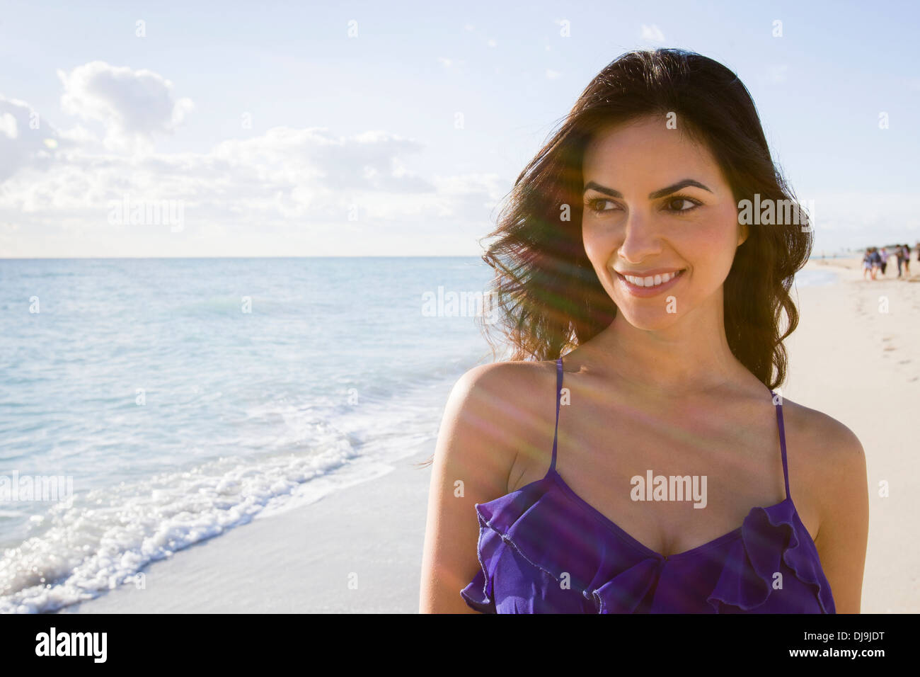 Hispanic woman walking on beach Stock Photo - Alamy