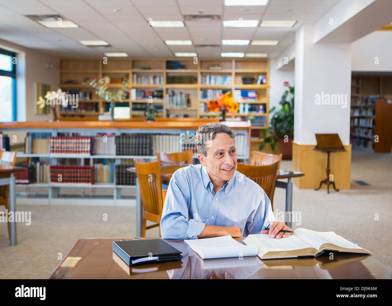 Man reading in library Stock Photo - Alamy