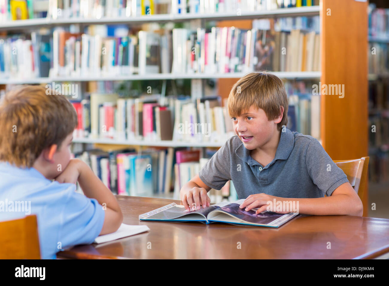 Students reading together in library Stock Photo - Alamy
