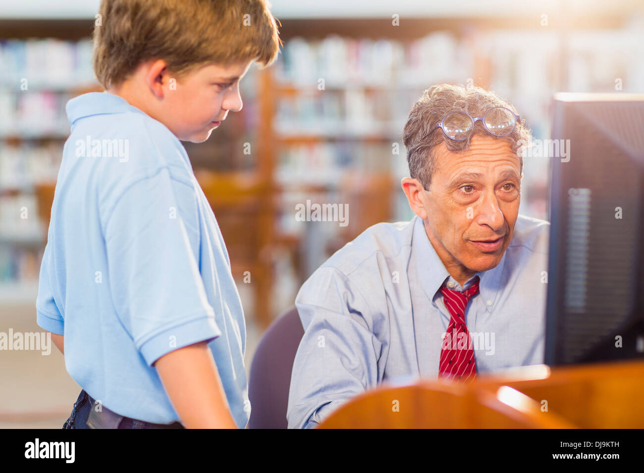 Teacher and student working at computer Stock Photo - Alamy