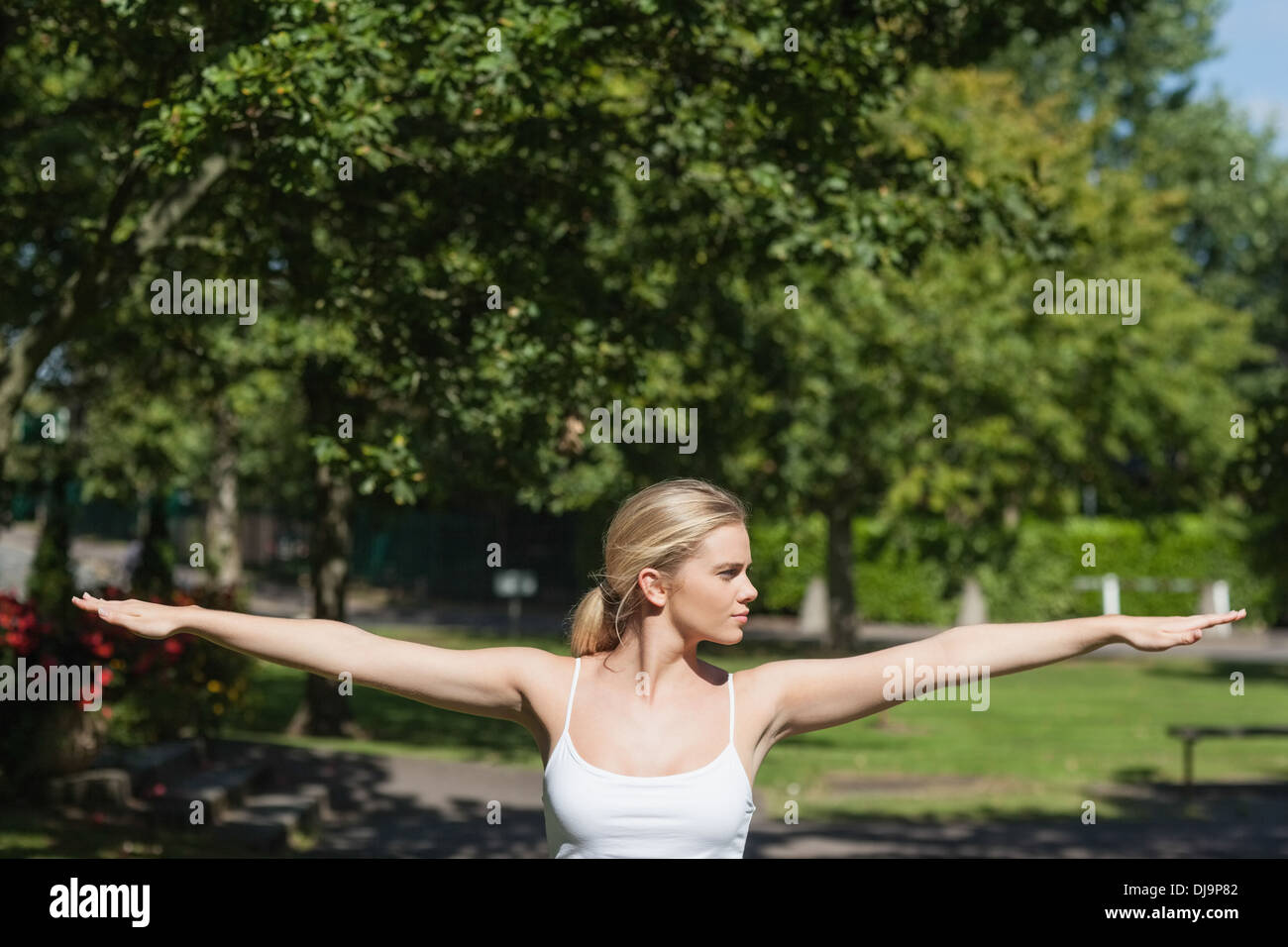 Young woman doing yoga spreading her arms Stock Photo - Alamy