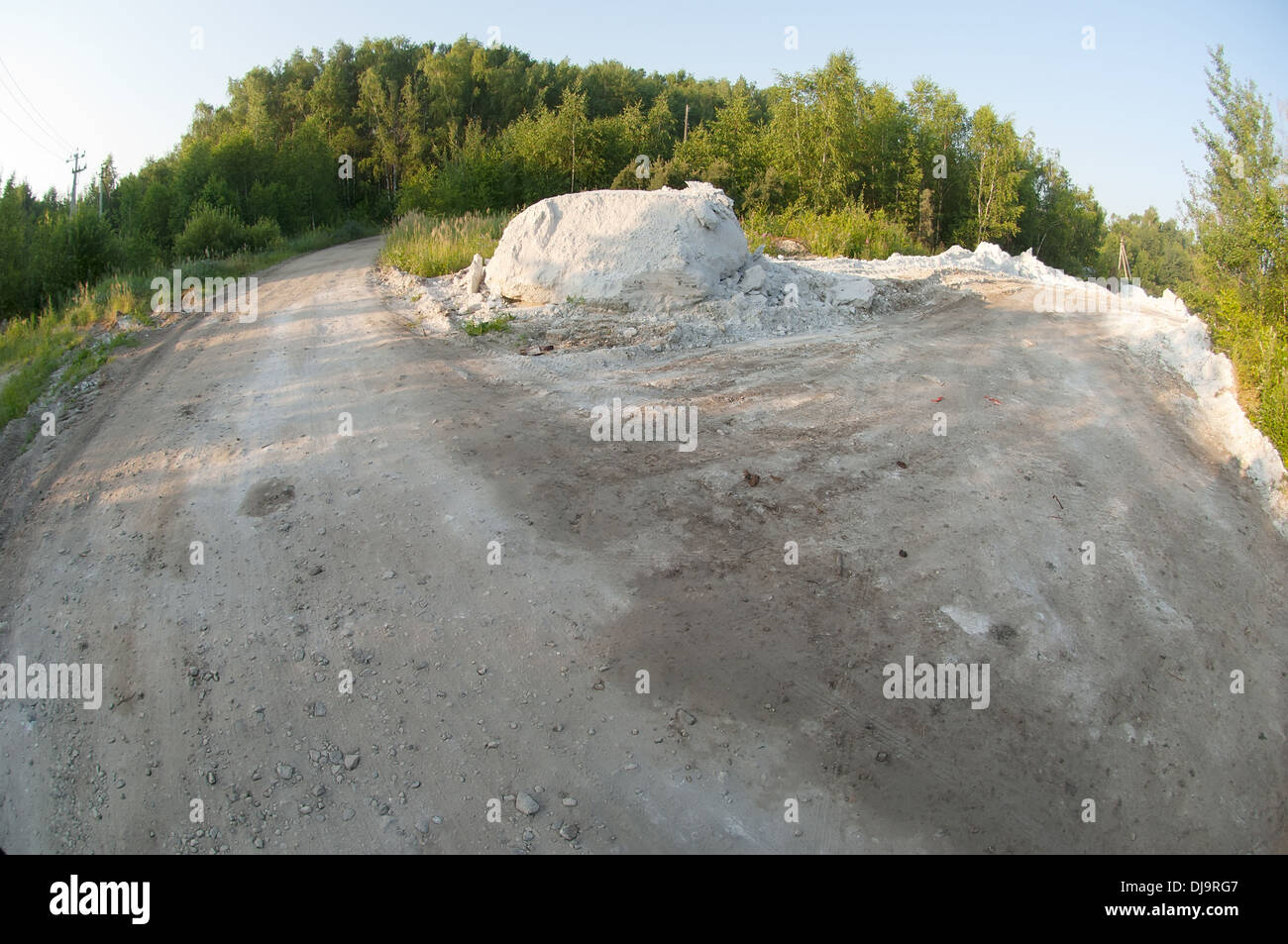 Wide angle sight to road with a big white rock Stock Photo - Alamy