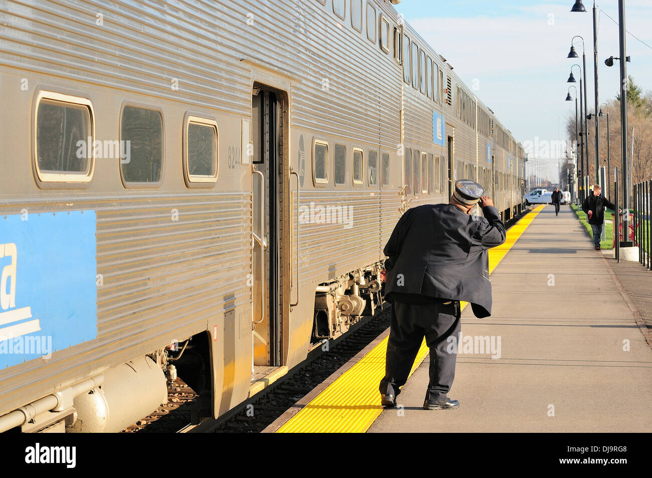 Train conductor waving hat to signal all clear Stock Photo - Alamy