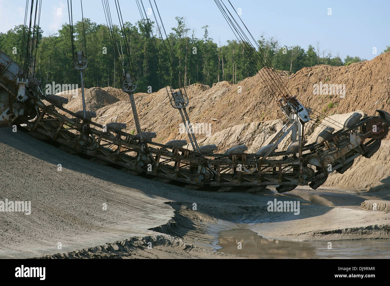 Mining machine dig sand on a geology factory Stock Photo - Alamy