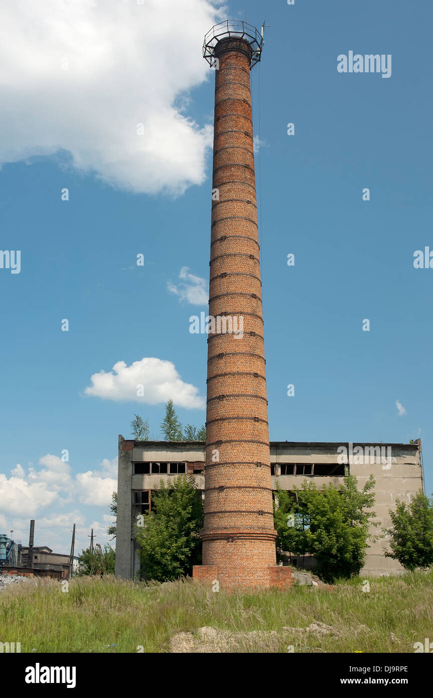 Brick built tall industrial chimney against blue cloudy sky Stock Photo ...