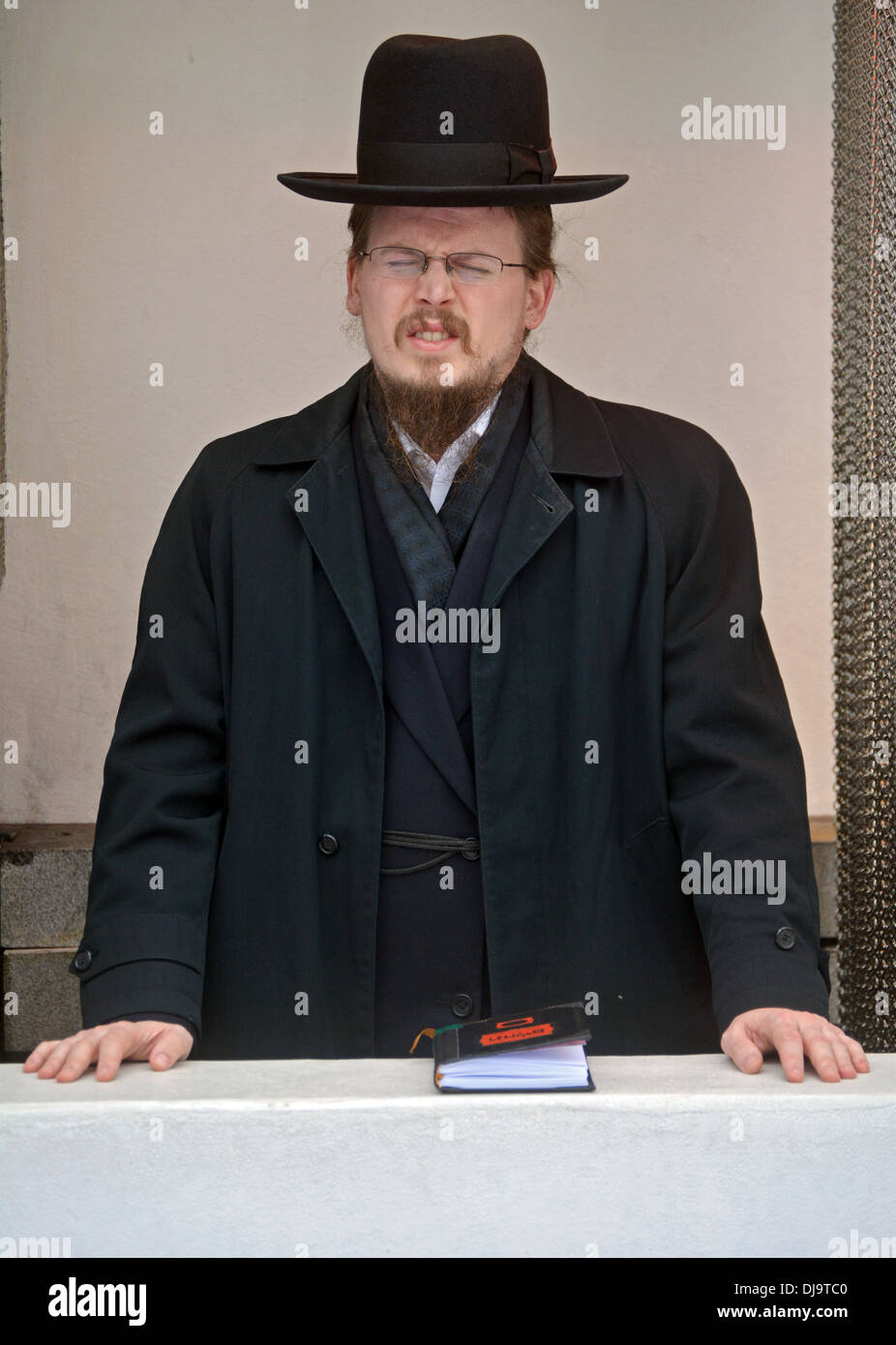 Religious Jewish man in fervent prayer at the Ohel, the burial place of ...