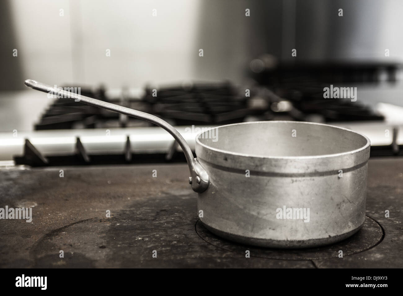 Chrome pot standing on hotplate in professional kitchen Stock Photo - Alamy