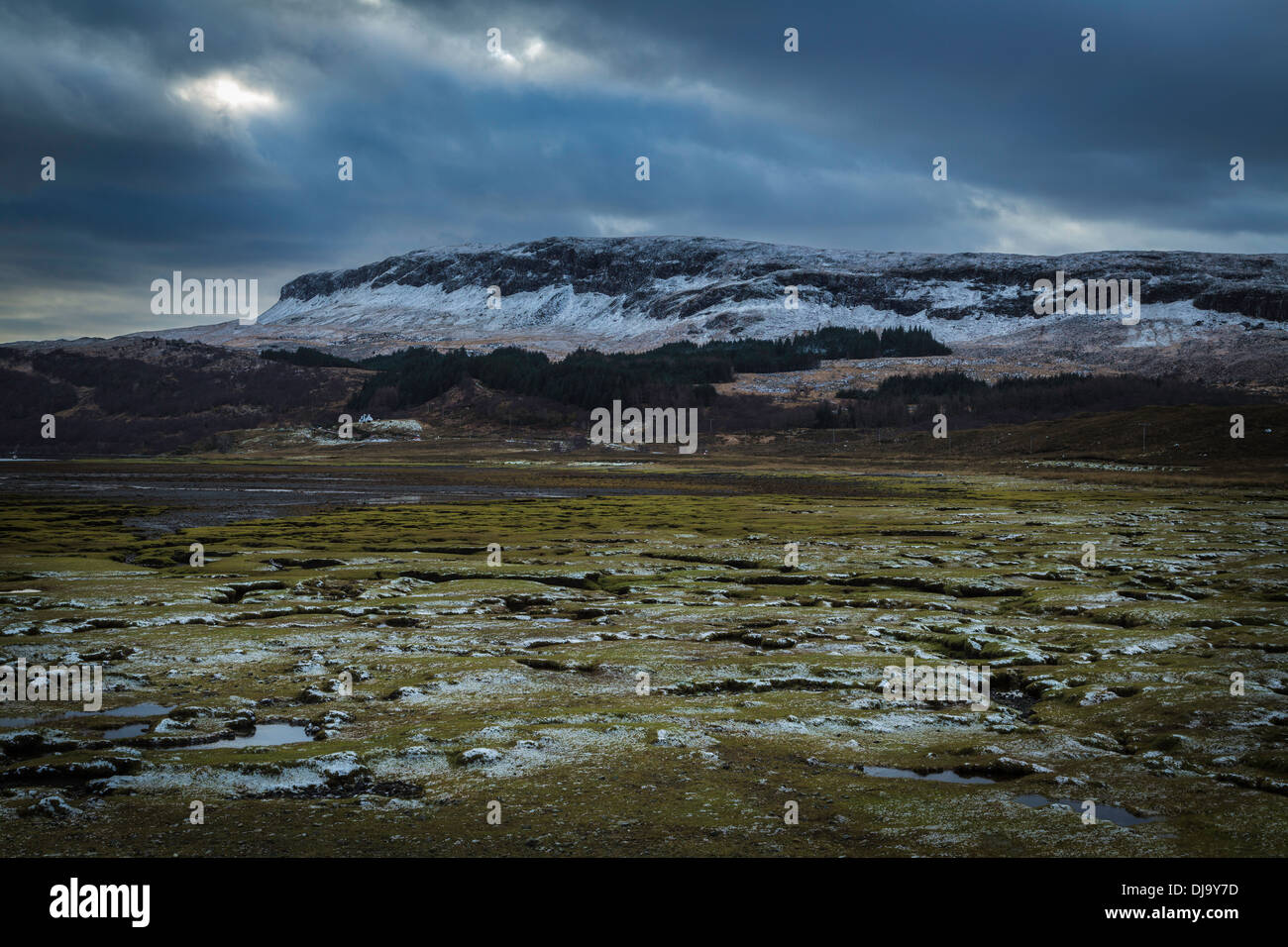 Frozen salt marshes on Loch Slapin with snow covered scree slopes of An ...