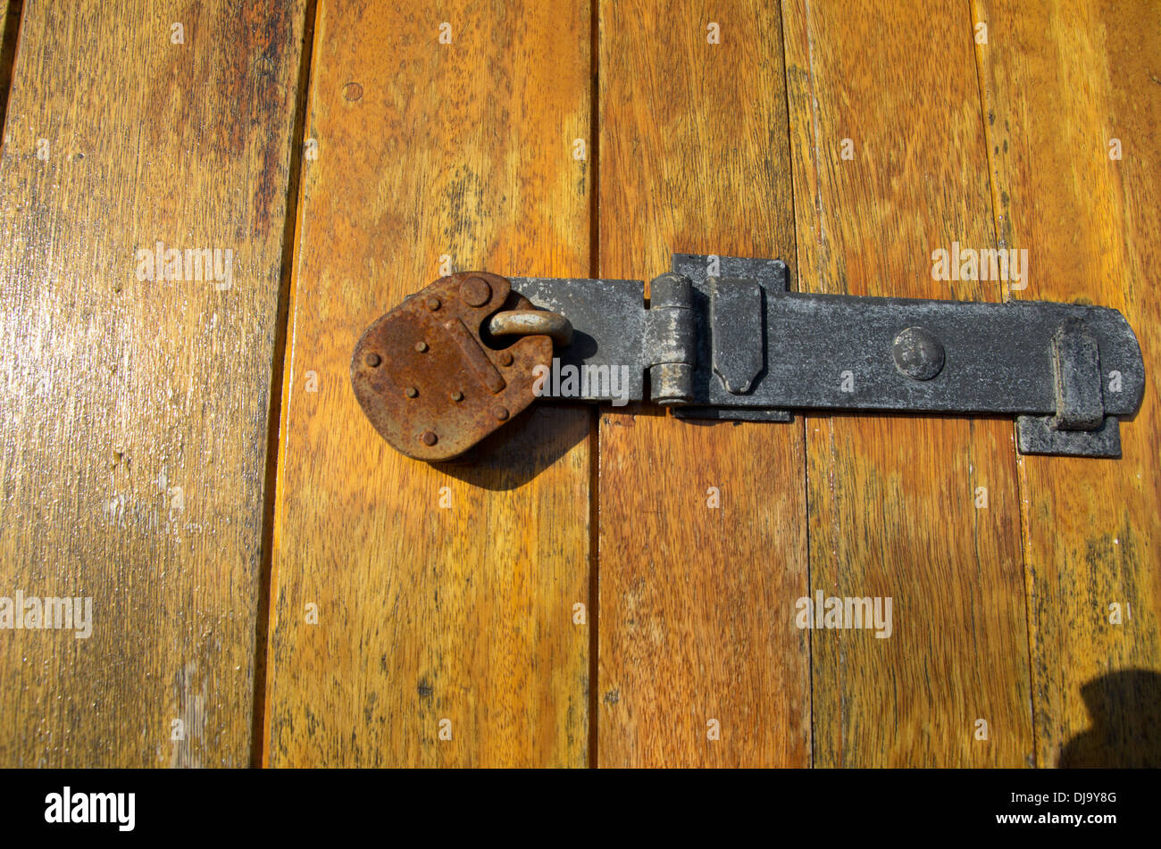 Wooden Shutter held shut and closed with lock Stock Photo - Alamy
