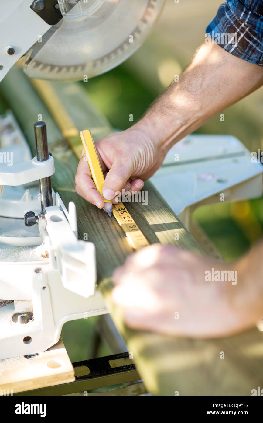 Carpenter Marking On Wood Using Ruler At Table Saw Stock Photo - Alamy