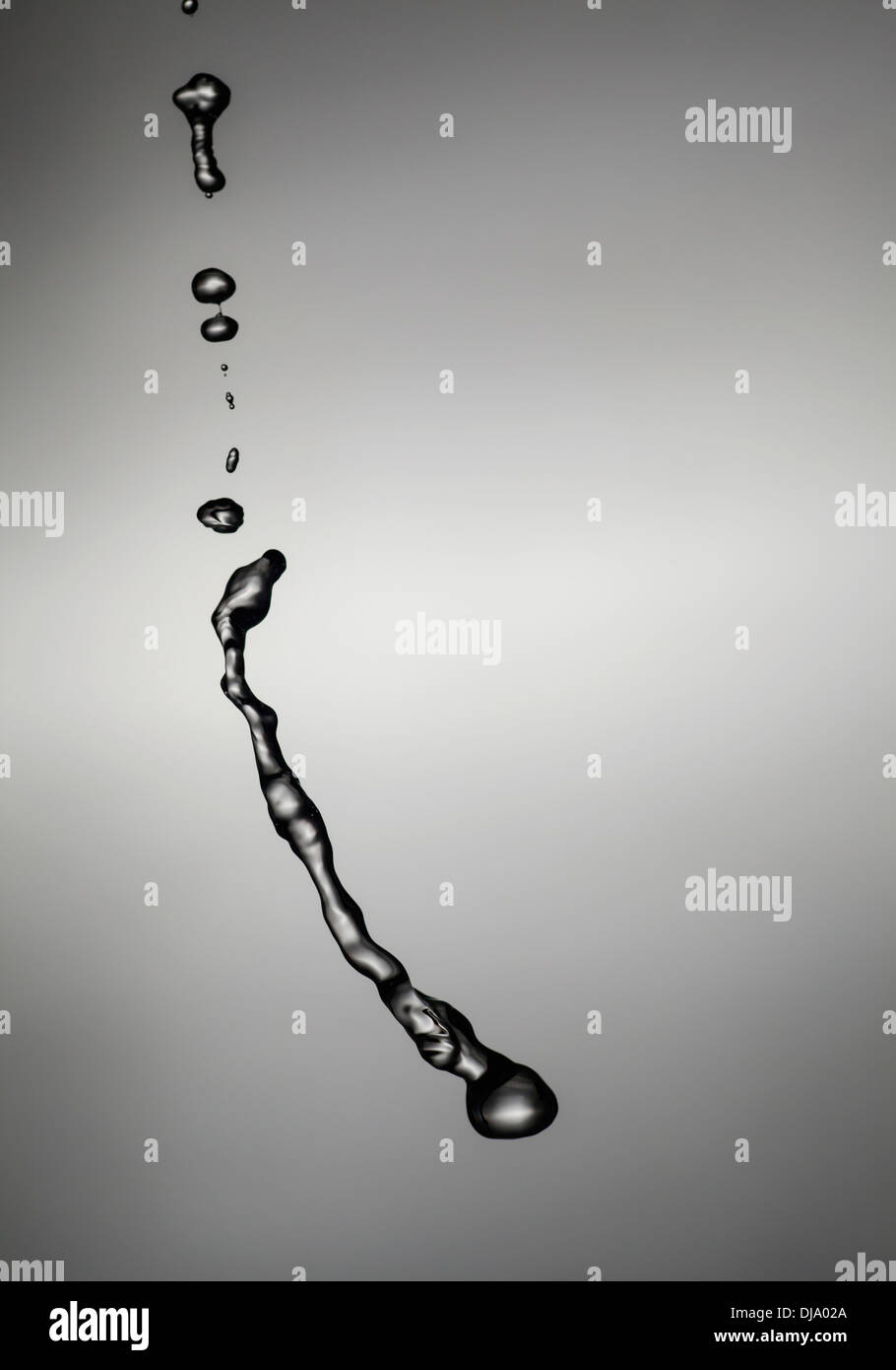 Falling water splashing with grey background Stock Photo - Alamy