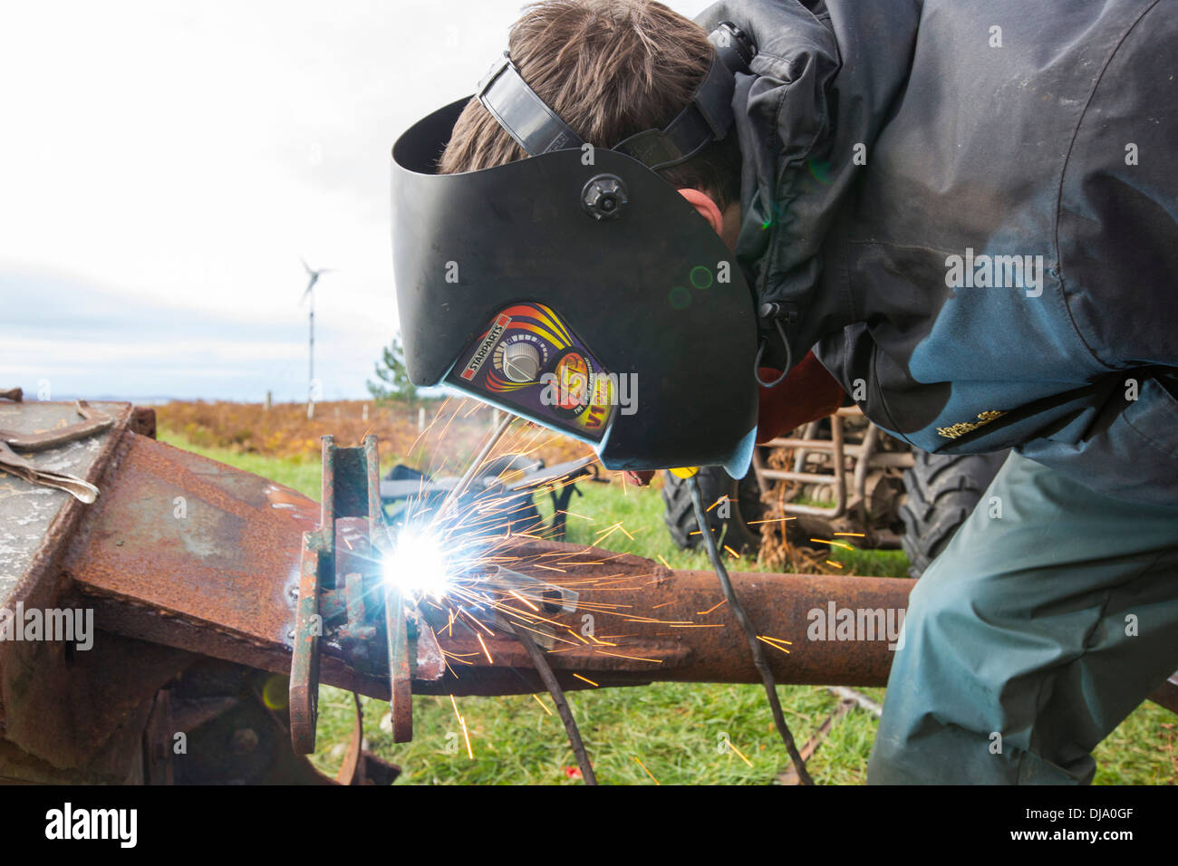 Hugh Piggott doing maintenance on his home made wind turbines in ...